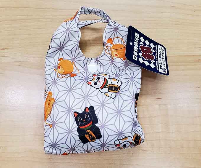 A foldable lucky cat eco-bag that folds small but carries big good fortune wherever you go.