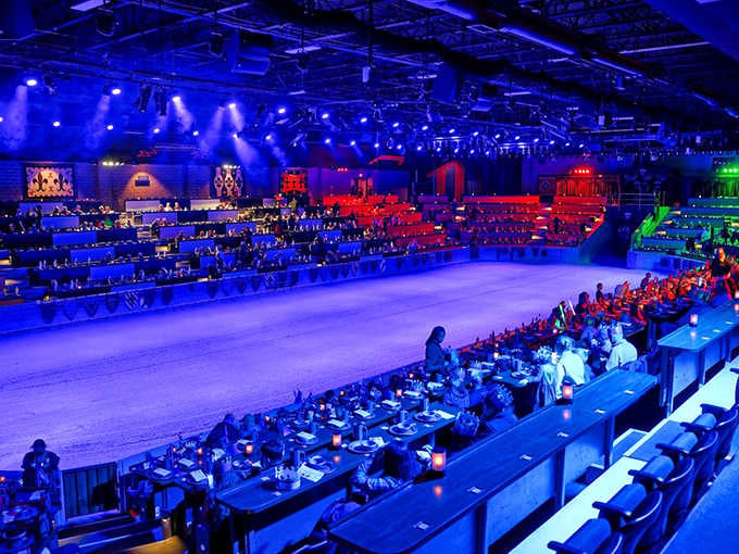 The arena glows under dramatic lighting, making every seat feel like the best seat in the house.