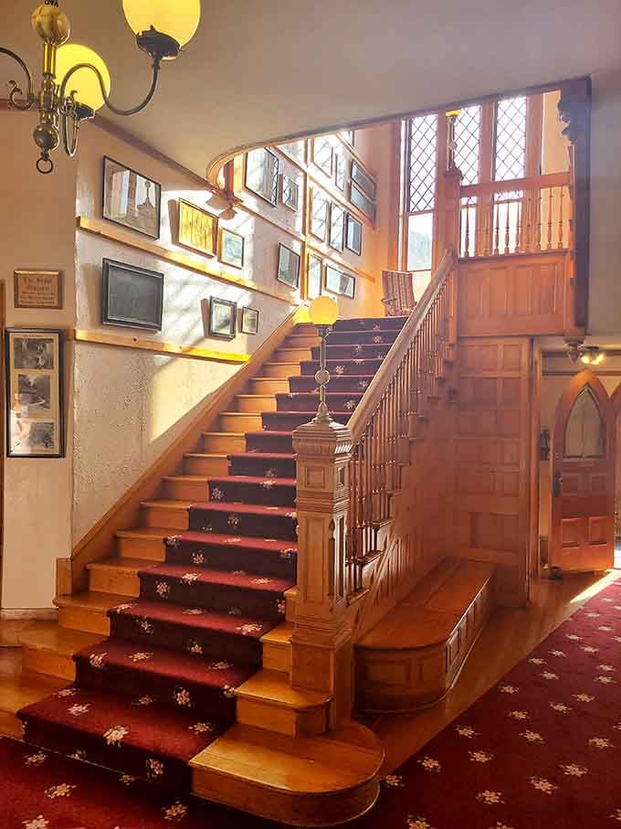 A grand staircase with a red carpet runner that makes every single step feel like a proper entrance.