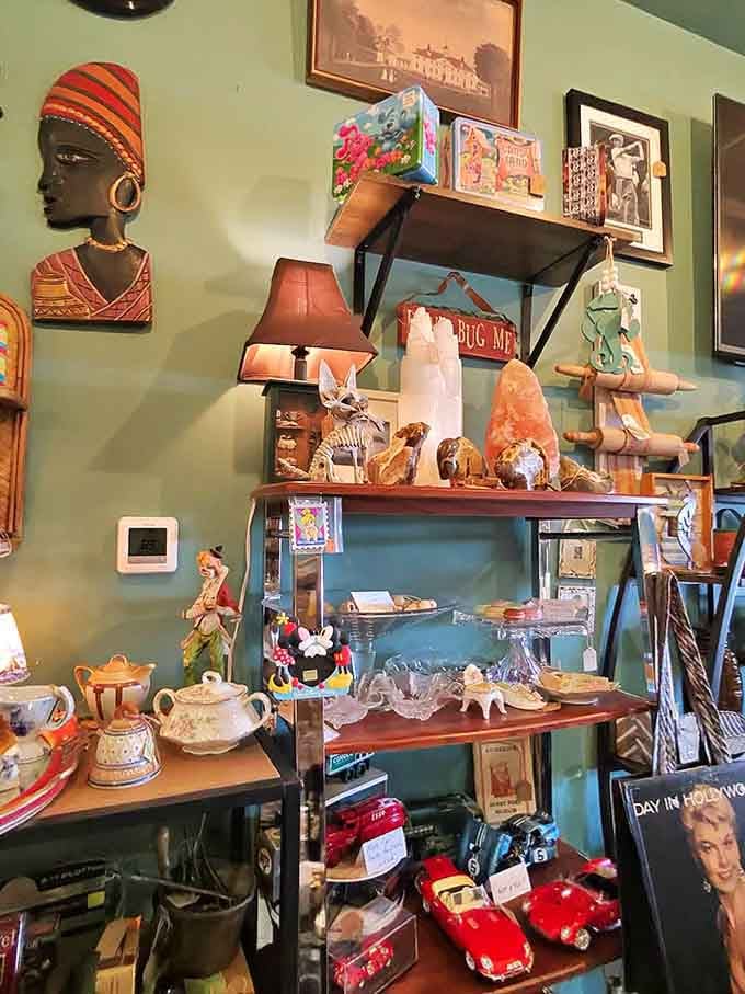 Teapots, toy cars, crystal dishes, and a frog figurine sharing one shelf, which is honestly the most Colorado thing ever.