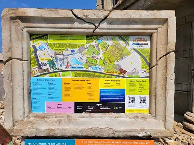 The park map framed in crumbling stone columns, because even your navigation guide deserves a little Greek mythology drama.