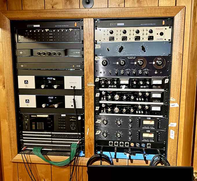 Racks of outboard gear stacked floor to ceiling, the kind of equipment that turned raw talent into timeless records.