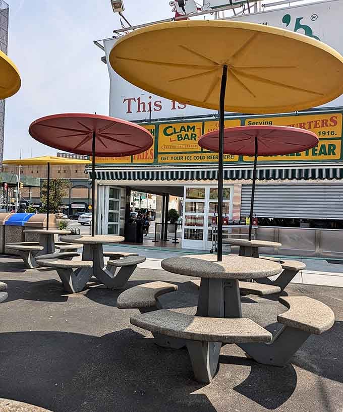 Big yellow and red umbrellas, round stone tables, and the Nathan's sign watching over everything. This outdoor spot earns its place in Brooklyn history.