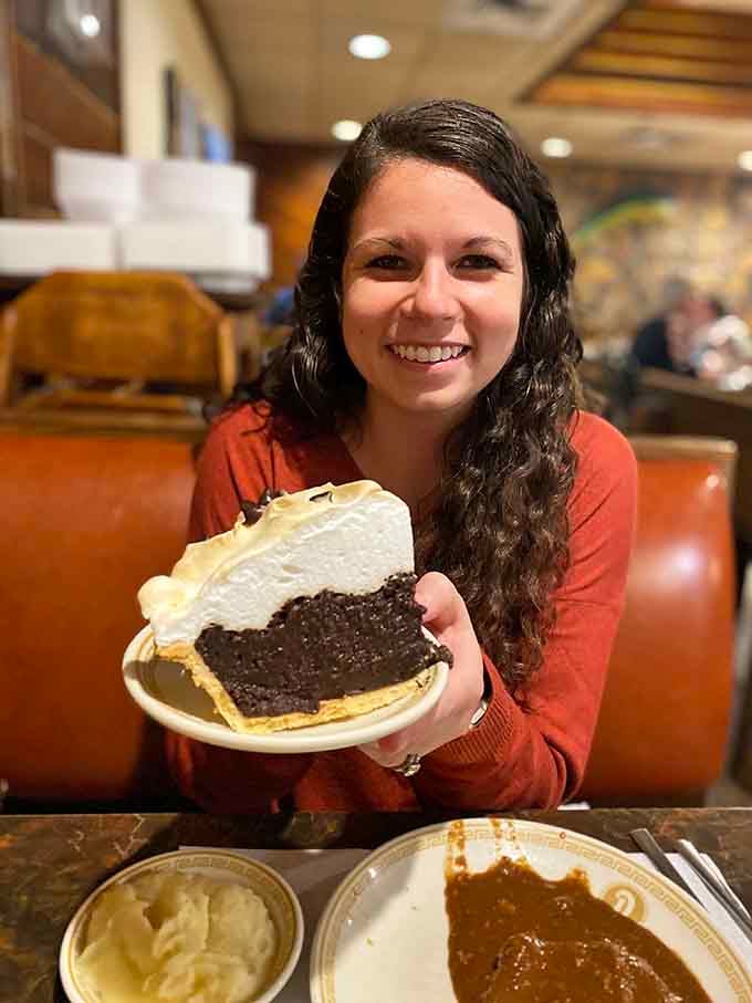 Pure joy, captured in one slice of chocolate pie. That smile says everything the words simply cannot.