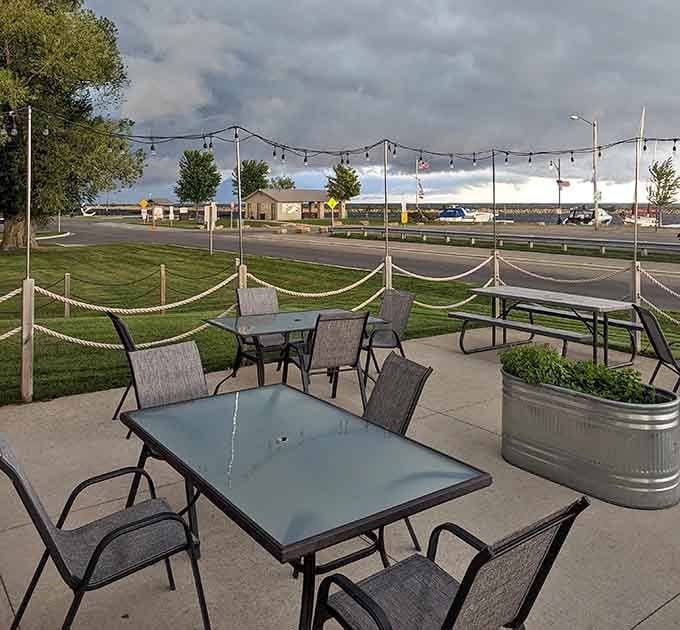 String lights, rope fencing, and a dramatic stormy sky over the harbor, this patio was built for the kind of evening you'll talk about for years.