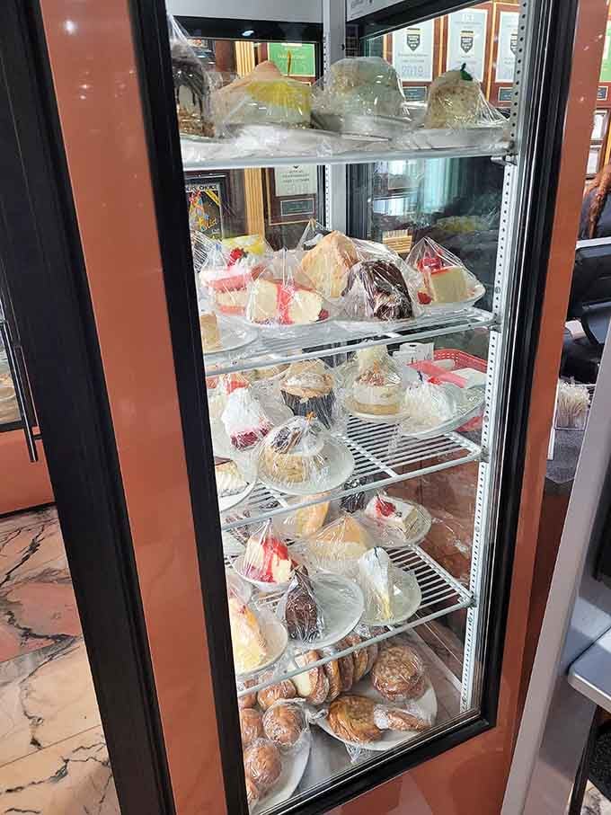 A glass case packed floor to ceiling with cakes, pastries, and pies, willpower officially has no jurisdiction here.