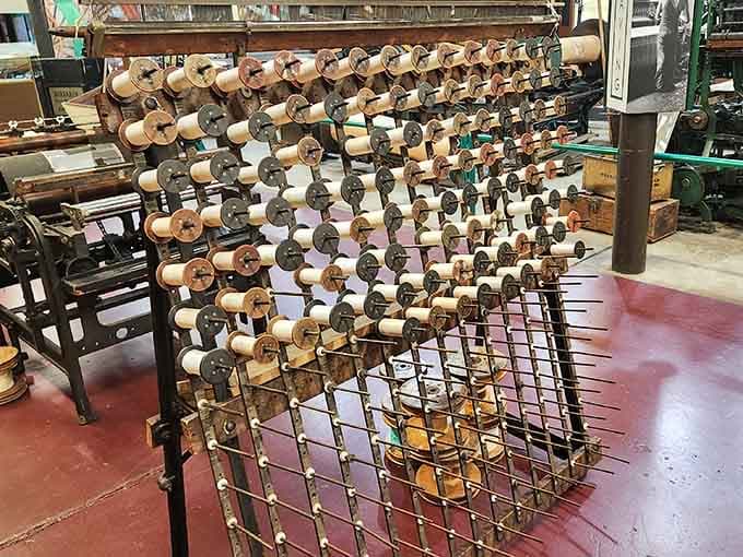 Hundreds of wooden spools stacked in perfect grid formation on this warp creel look like the world's most satisfying organizational project.
