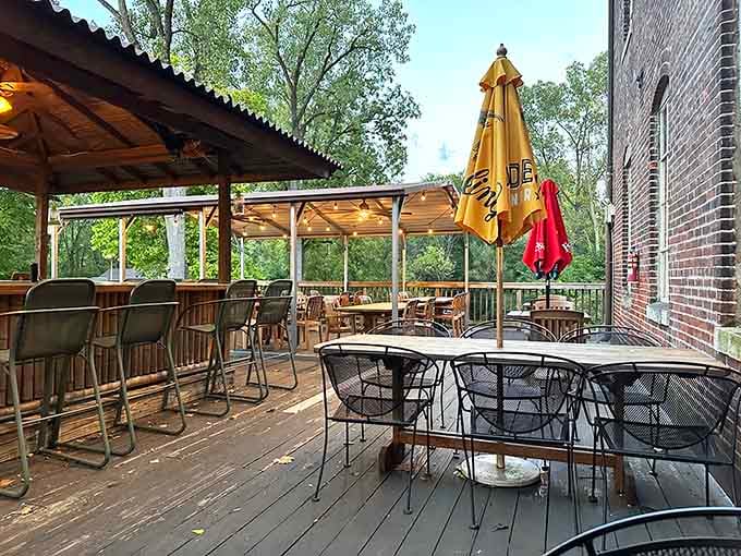 An outdoor deck surrounded by trees, with umbrella tables and fresh air. Dining al fresco never felt so effortlessly relaxed.