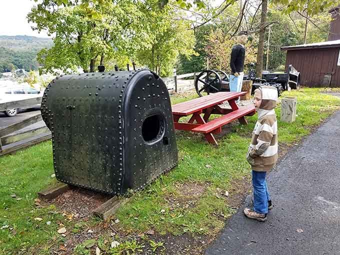Even a young visitor can't help stopping to inspect this massive old boiler sitting quietly on the grounds.