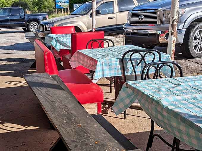 Checkered tablecloths and red vinyl chairs outside. Honestly, this porch seating situation deserves its own fan club.