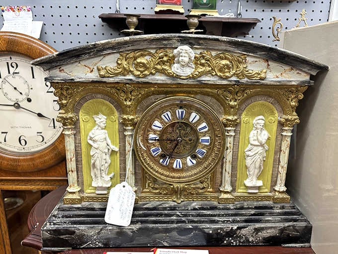 A gilded mantel clock flanked by classical figures. Time stopped looking this good a long time ago.