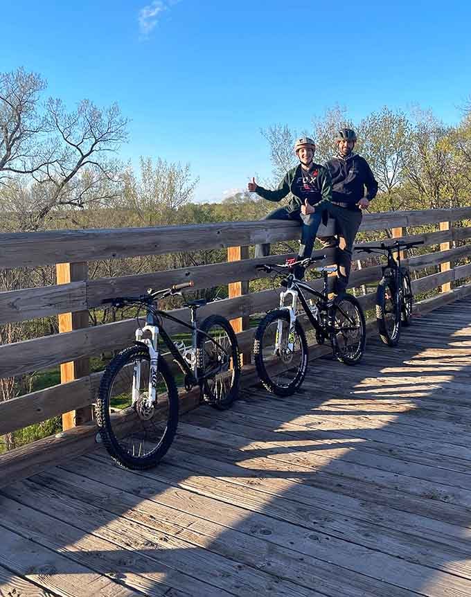 Two cyclists pause to appreciate what a century of history looks like from above.