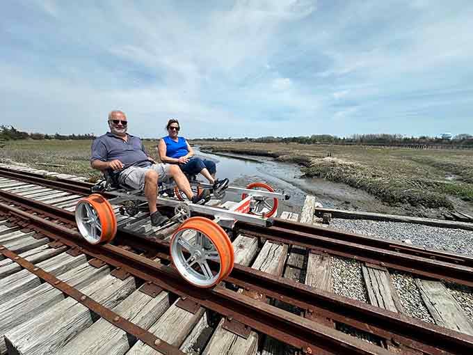 A couple glides over the marsh trestle together, with the kind of view that makes everything feel lighter.