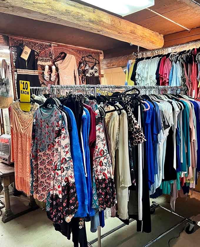 Racks of colorful clothing tucked inside a rustic wooden space, where every hanger holds a potential favorite.