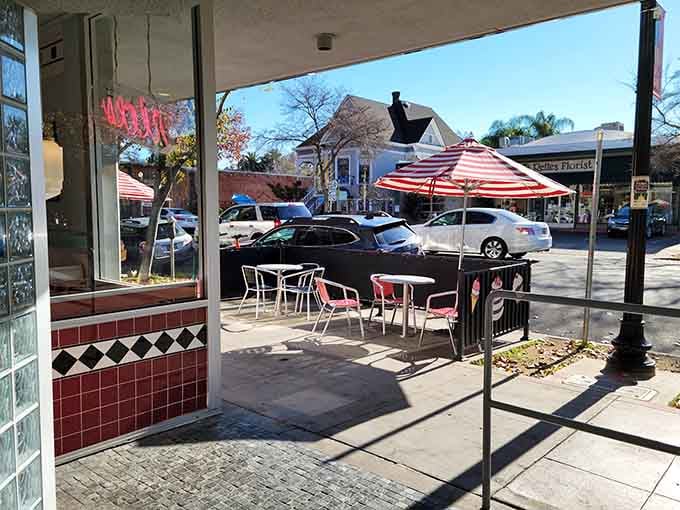 Outdoor seating under a striped umbrella, because enjoying dessert in the California sunshine is a perfectly valid life plan.