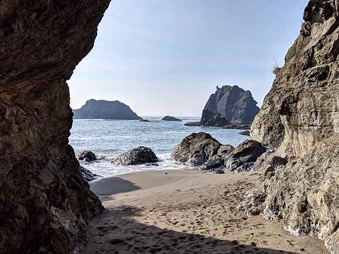 A massive headland rising straight from the surf, looking permanent and unbothered in the most magnificent way possible.