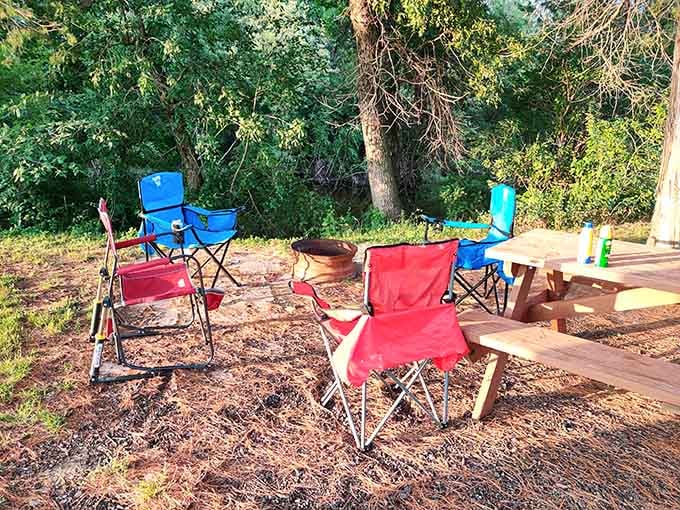 Camping chairs around a fire pit, trees all around. The only agenda here is having absolutely no agenda.