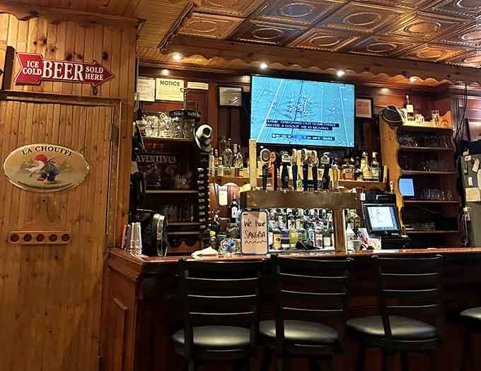 A proper bar stocked and ready, with cold beer on tap and a TV overhead. Comfort, defined.