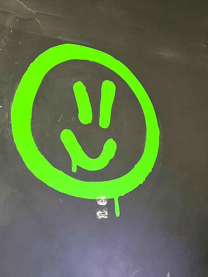 That neon green smiley face says everything. You walk in stressed, and you walk out looking exactly like this.