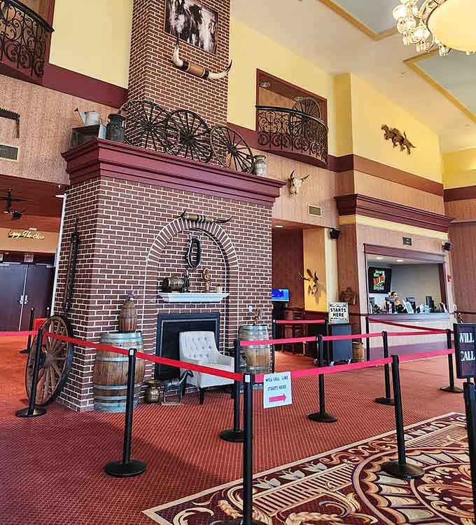A brick fireplace, wagon wheels, and longhorn mounts greet you before the show even begins. Consider yourself warned.