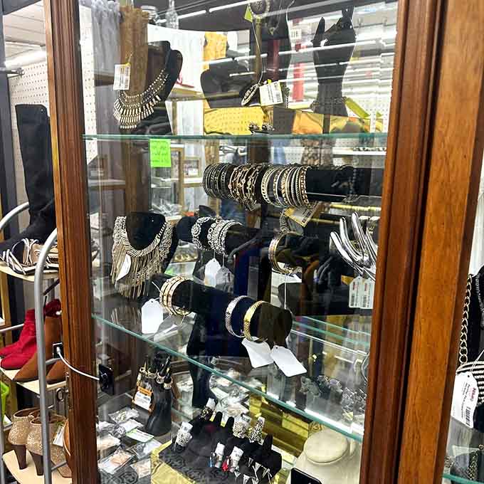 A glass case full of bold costume jewelry, necklaces, bangles, and earrings that know exactly how to make an entrance.