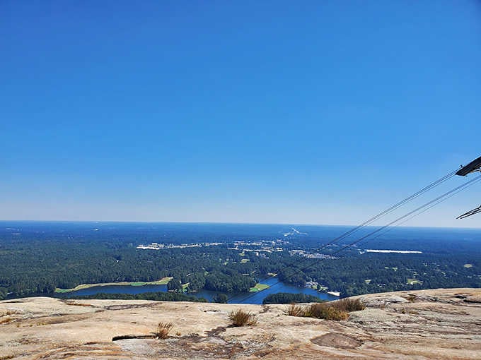 Hike to the top and earn these sweeping views of lakes, forests, and distant city, all spread before you.