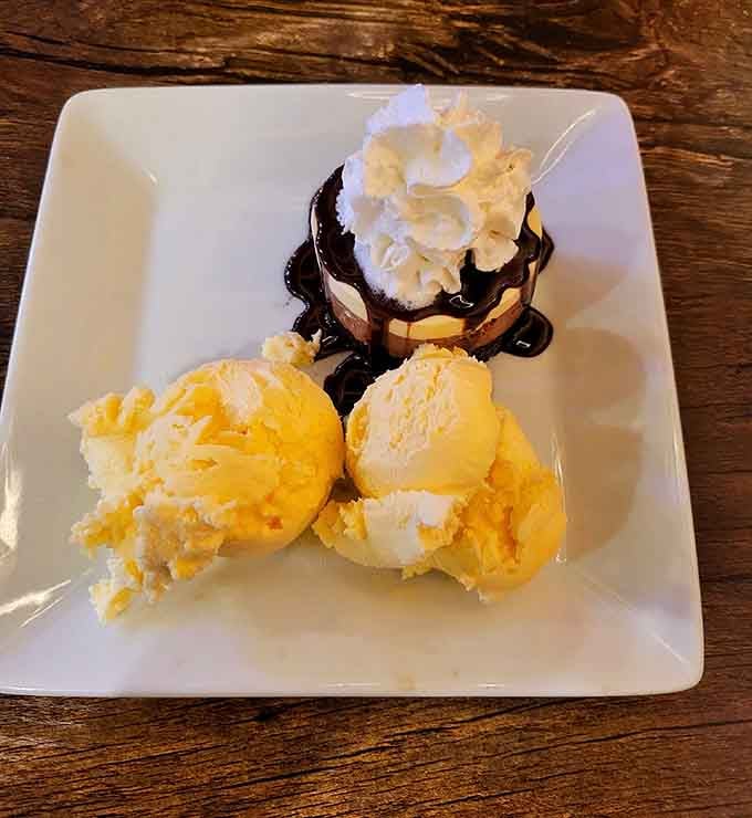 Scoops of ice cream beside a chocolate-drizzled dessert cup topped with whipped cream. A sweet finish nobody saw coming, but everyone appreciates.