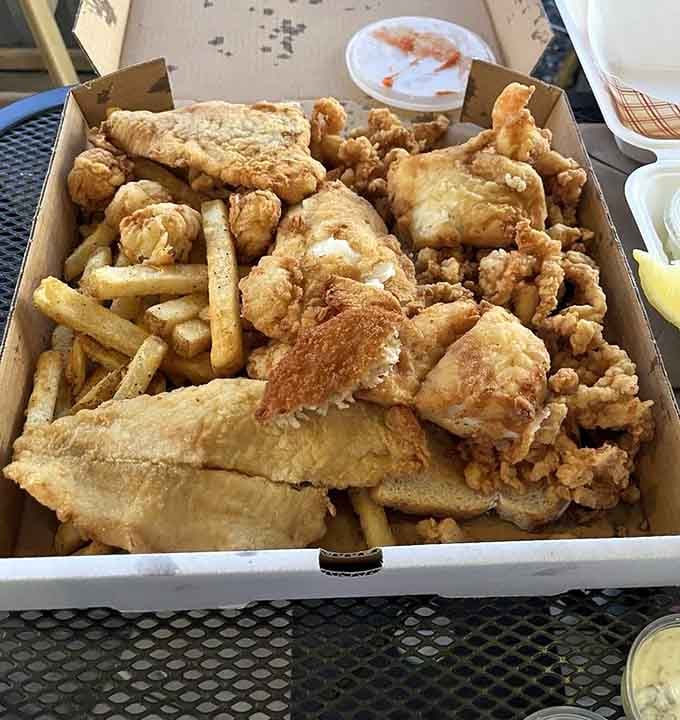 A cardboard box overflowing with fried fish, clams, and fries is the seafood equivalent of winning the lottery.