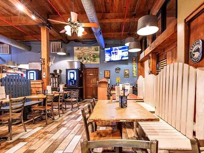 Warm wood tones, a ceiling fan spinning slowly, and brewery signage on the wall. This room invites you to stay awhile.