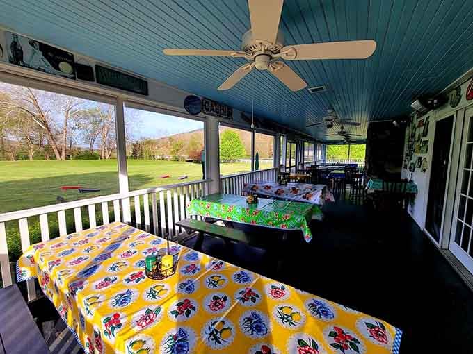 Colorful tablecloths, ceiling fans, and a sweeping green valley view. This porch is proof that outdoor dining doesn't need to be fancy.
