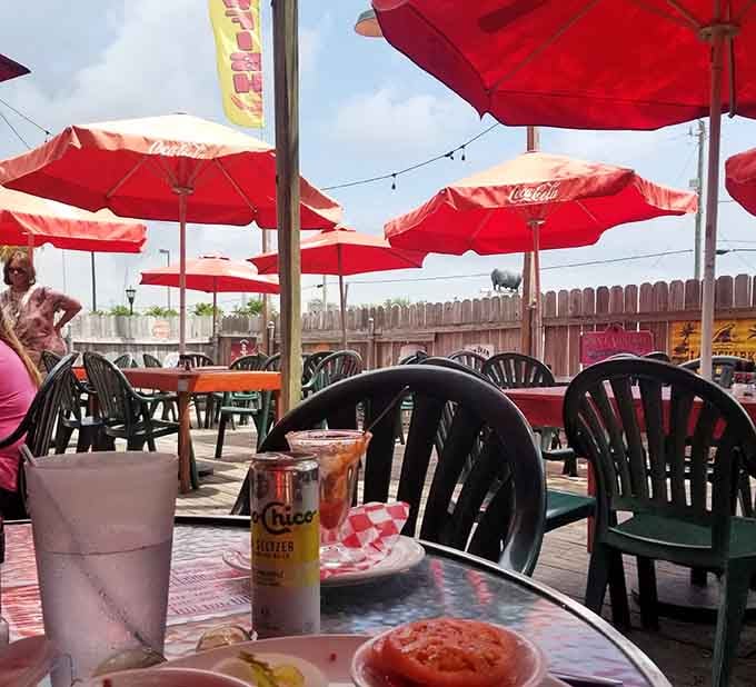 Red umbrellas, open sky, and good food on the table. Outdoor dining doesn't get more laid-back than this.