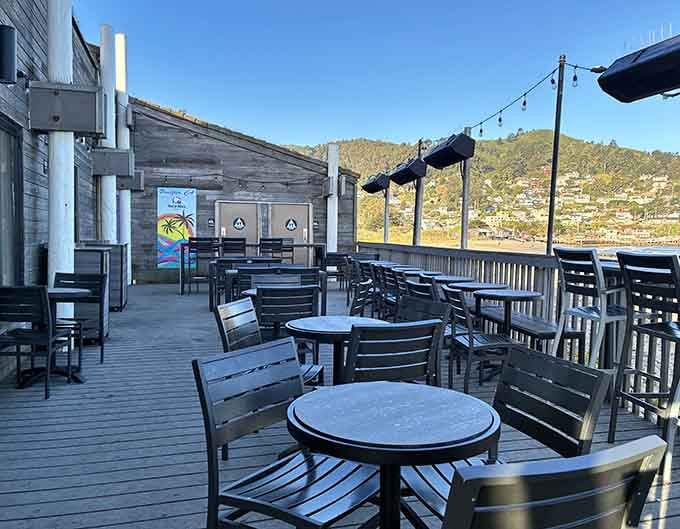 The outdoor deck at Taco Bell Cantina Pacifica sits empty and ready, with the hills of Pacifica framing the background.
