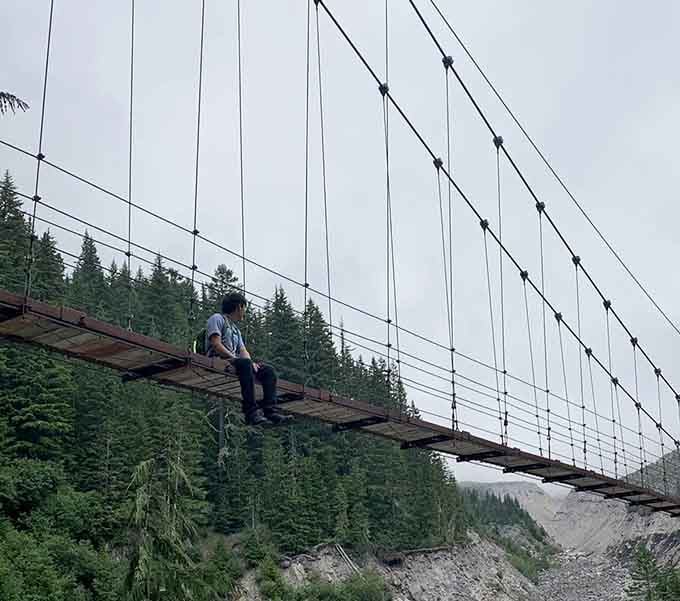 Sometimes the best view requires sitting still on a swaying bridge, contemplating life's bigger questions.