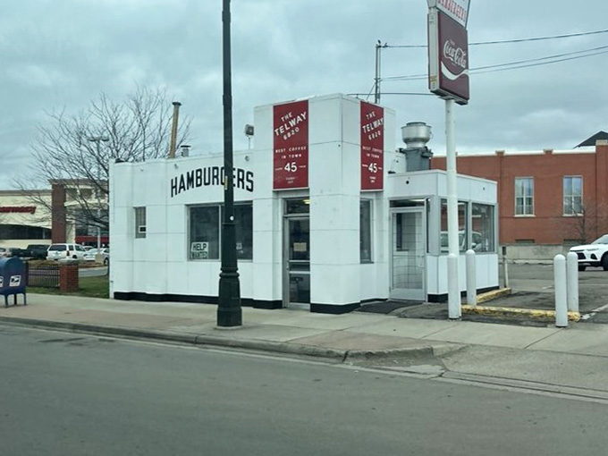 A classic, retro white diner building stands prominently on the street corner, ready to serve up its famous slider hamburgers.