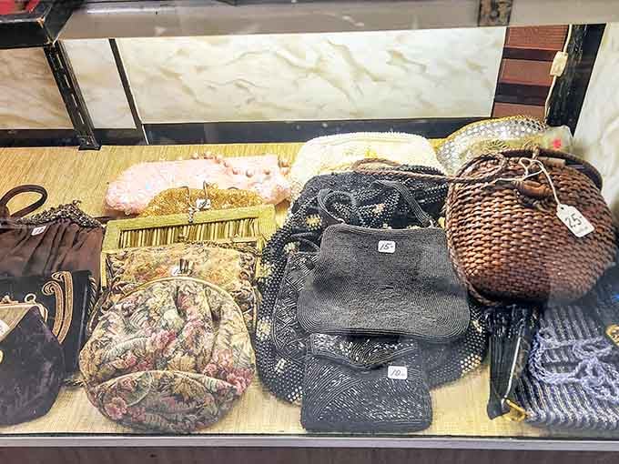Beaded evening bags, tapestry clutches, and woven basket purses tucked behind glass, each one carrying the quiet elegance of a different decade entirely.