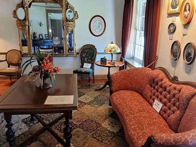 Antique portraits, a Tiffany-style lamp, and a button-tufted settee, this sitting room means serious, unapologetic business.