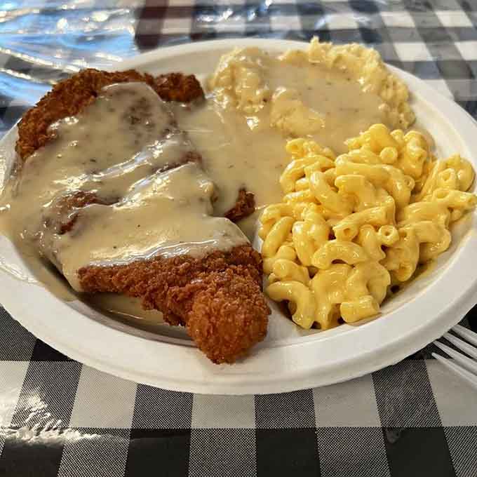 Pork chops, mac and cheese, and mashed potatoes create the holy trinity of comfort food satisfaction.