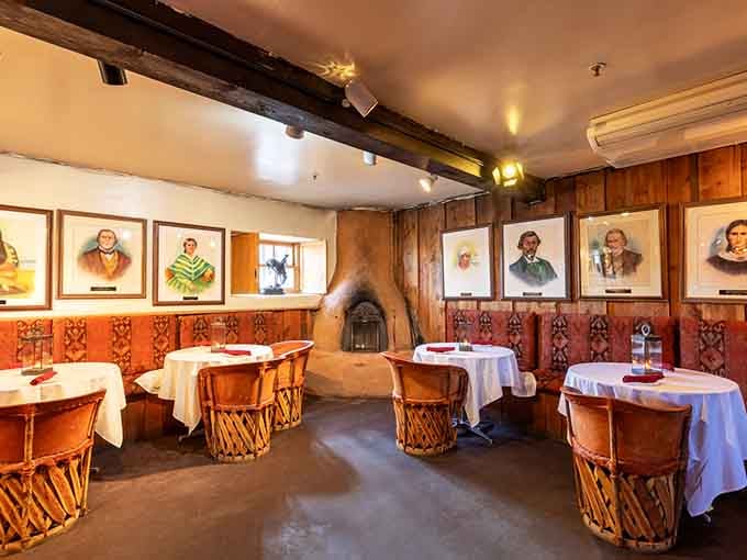 Adobe fireplace, painted portraits, and drum-style chairs. This room tells a story before you even open the menu.