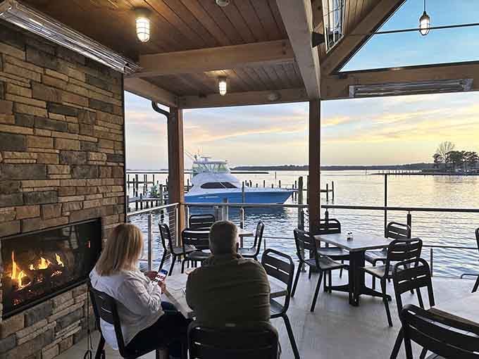 An outdoor fireplace, water views, and a yacht docked nearby. Somebody clearly made excellent life choices today.