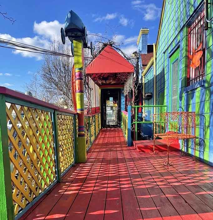 A red painted walkway leading to the entrance, framed in green and yellow, feels like the opening credits of a very good movie.