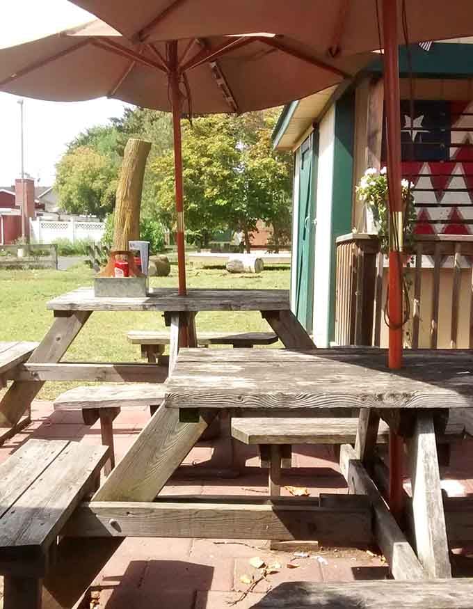 Picnic tables under a shady umbrella, because sometimes the best seat in the house is actually outside the house.