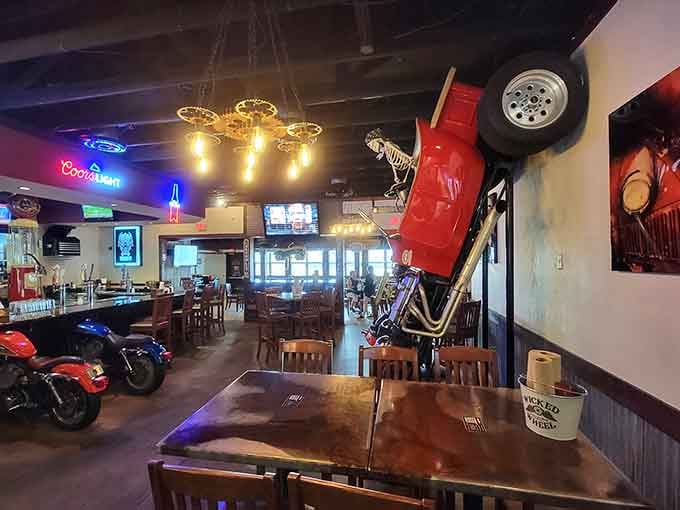 A red car mounted on the wall mid-wheelie with a skeleton inside, because why not make dinner unforgettable.