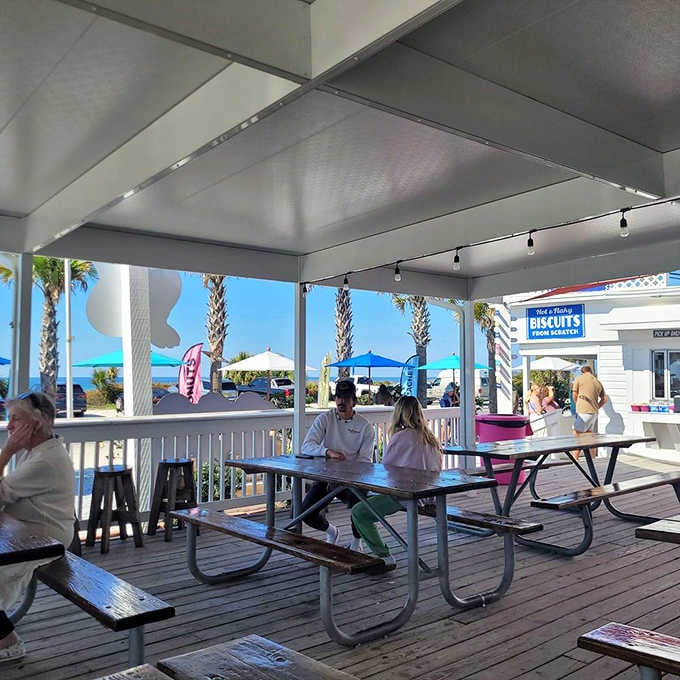 An open-air deck with palm trees, picnic tables, and Gulf breezes, the kind of dining room no architect could design better.
