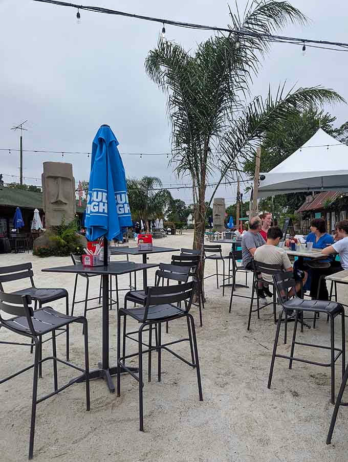 Sandy floors, palm trees, and Easter Island statues watching over diners, this outdoor setup is genuinely one of a kind.
