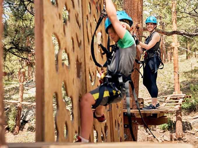 A wooden climbing wall in the pines, where parents cheer and kids pretend they weren't nervous at all.