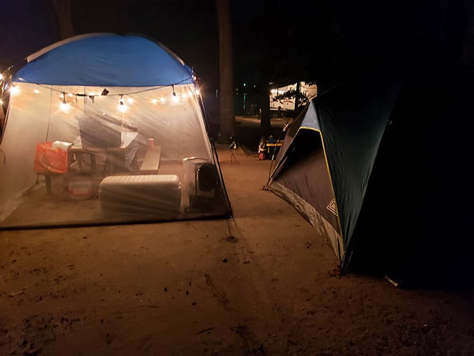 String lights glowing against the dark, turning a simple campsite into something that feels surprisingly cozy and a little magical.