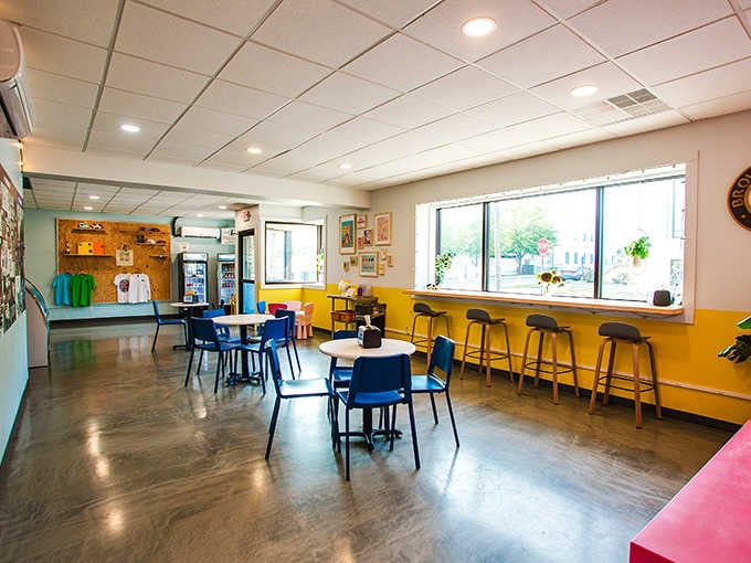 Bright blue chairs, big windows, and walls that feel like a Saturday morning cartoon brought to life.