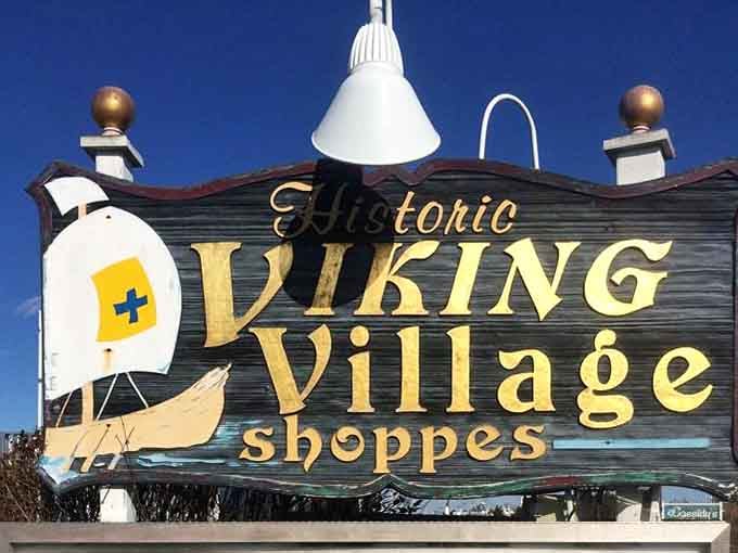 The Historic Viking Village Shoppes sign welcomes you with golden letters and a promise of authentic maritime character.