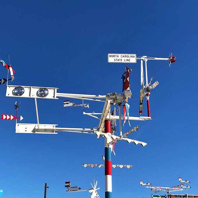 Only Vollis Simpson would put a North Carolina State Line sign on a whirligig and make it feel completely natural.