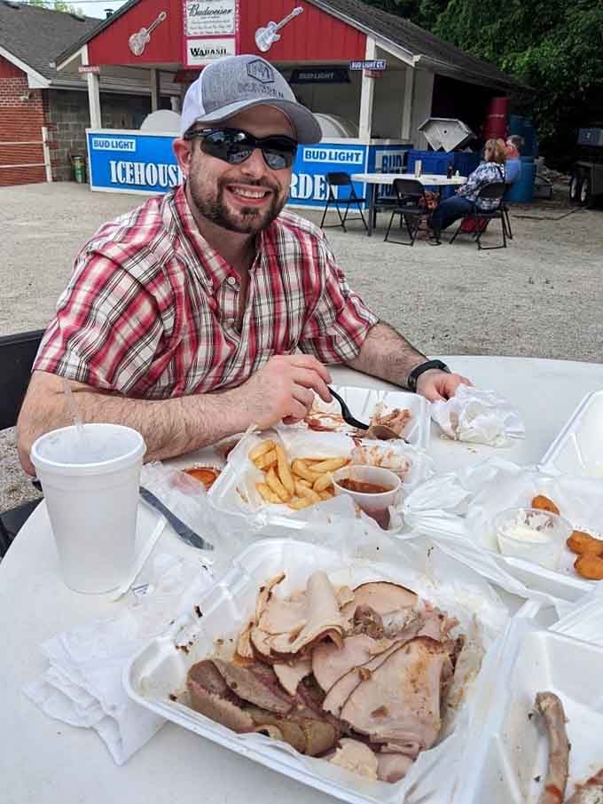 When a man smiles like that over a table full of smoked meat, you know the food is doing its job perfectly.